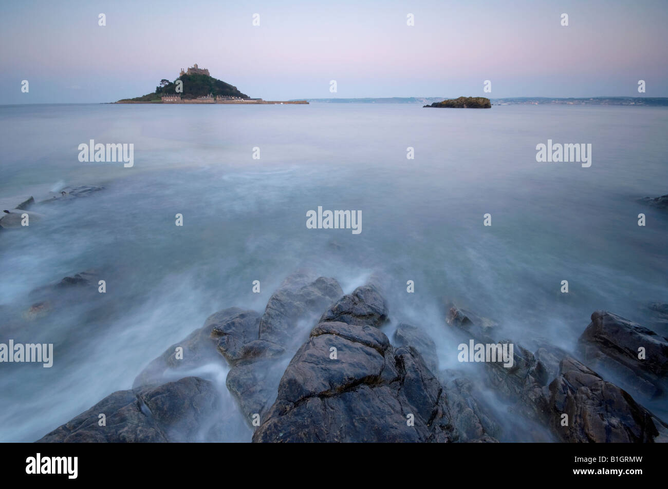 Waves washing in over foreshore rocks at St Michaels Mount at dawn ...