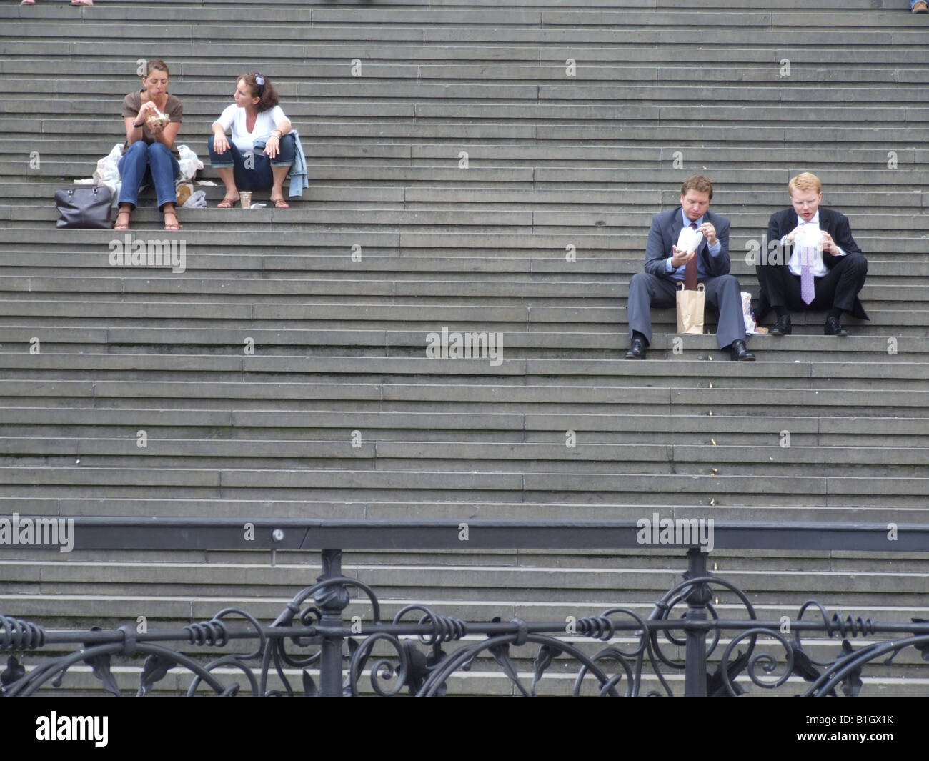 commuters eating lunch on steps on berlin, germany Stock Photo - Alamy