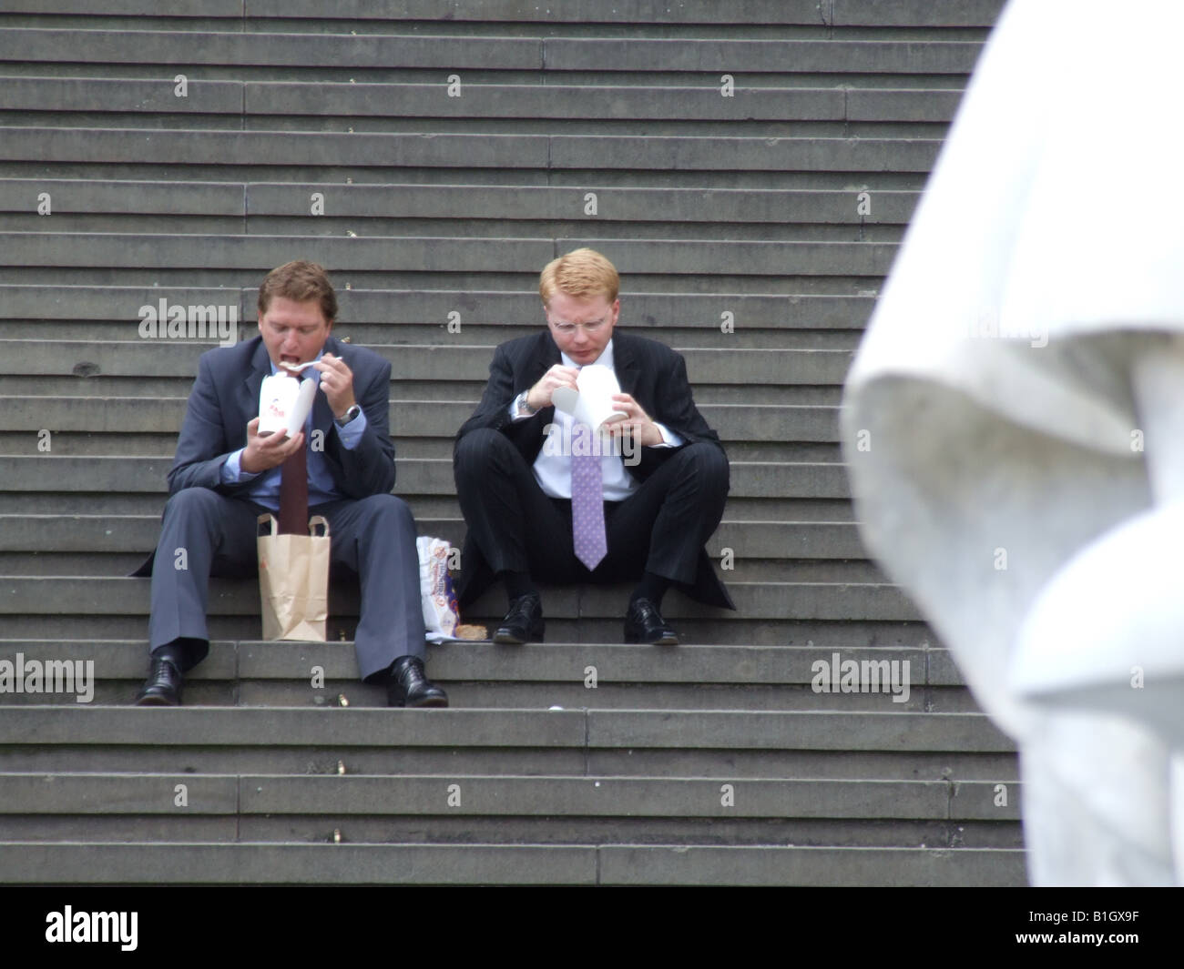 commuters eating lunch on steps on berlin, germany Stock Photo - Alamy