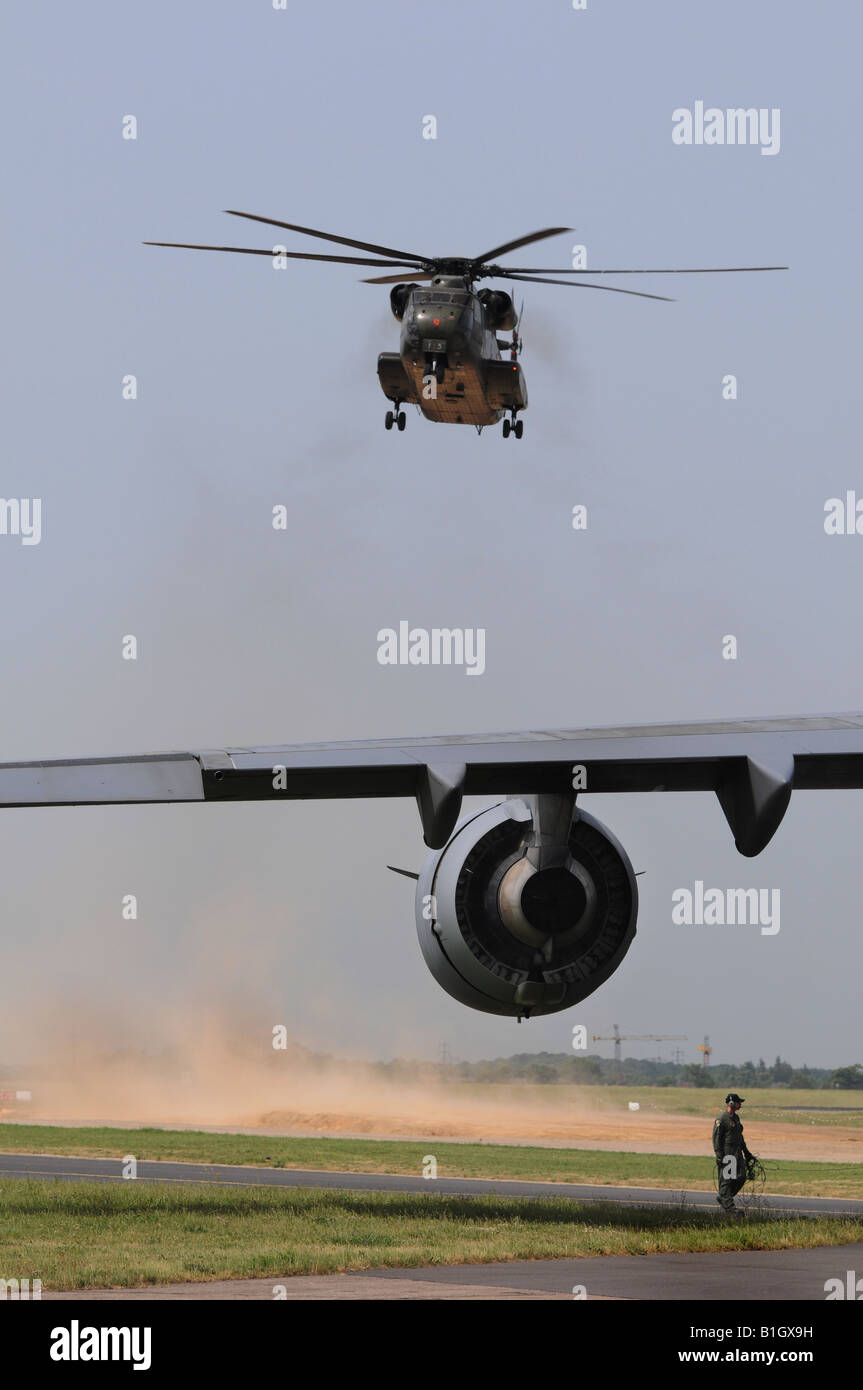 A german CH-53G landing with military transporter and crew on runway ...