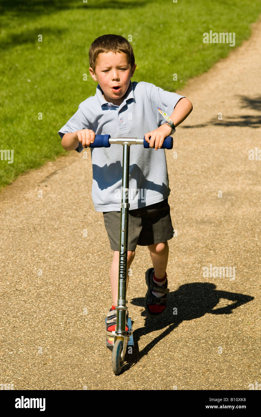 A child riding a scooter Stock Photo - Alamy