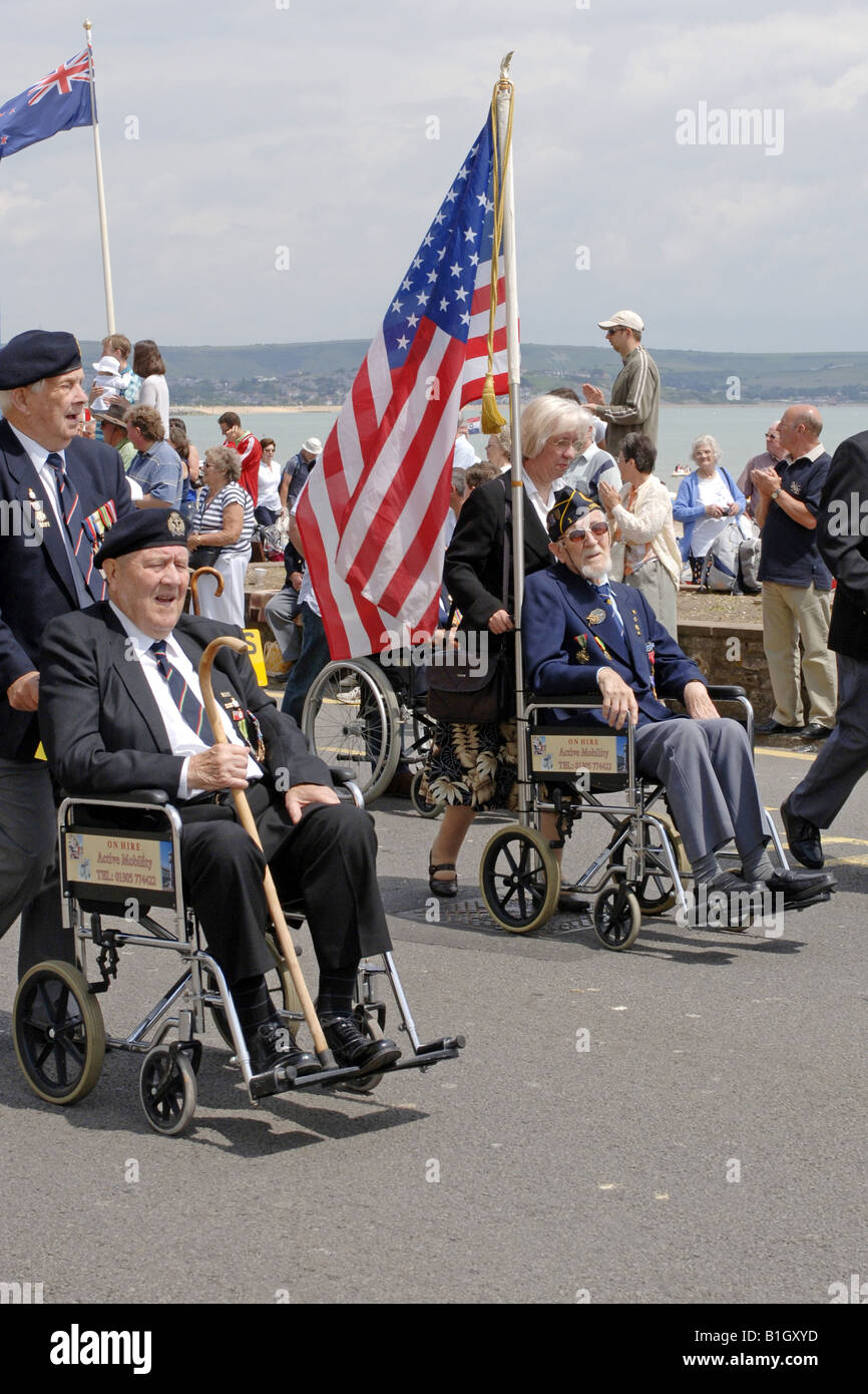 American VFW with the Stars and stripes is pushed in his wheelchair at ...
