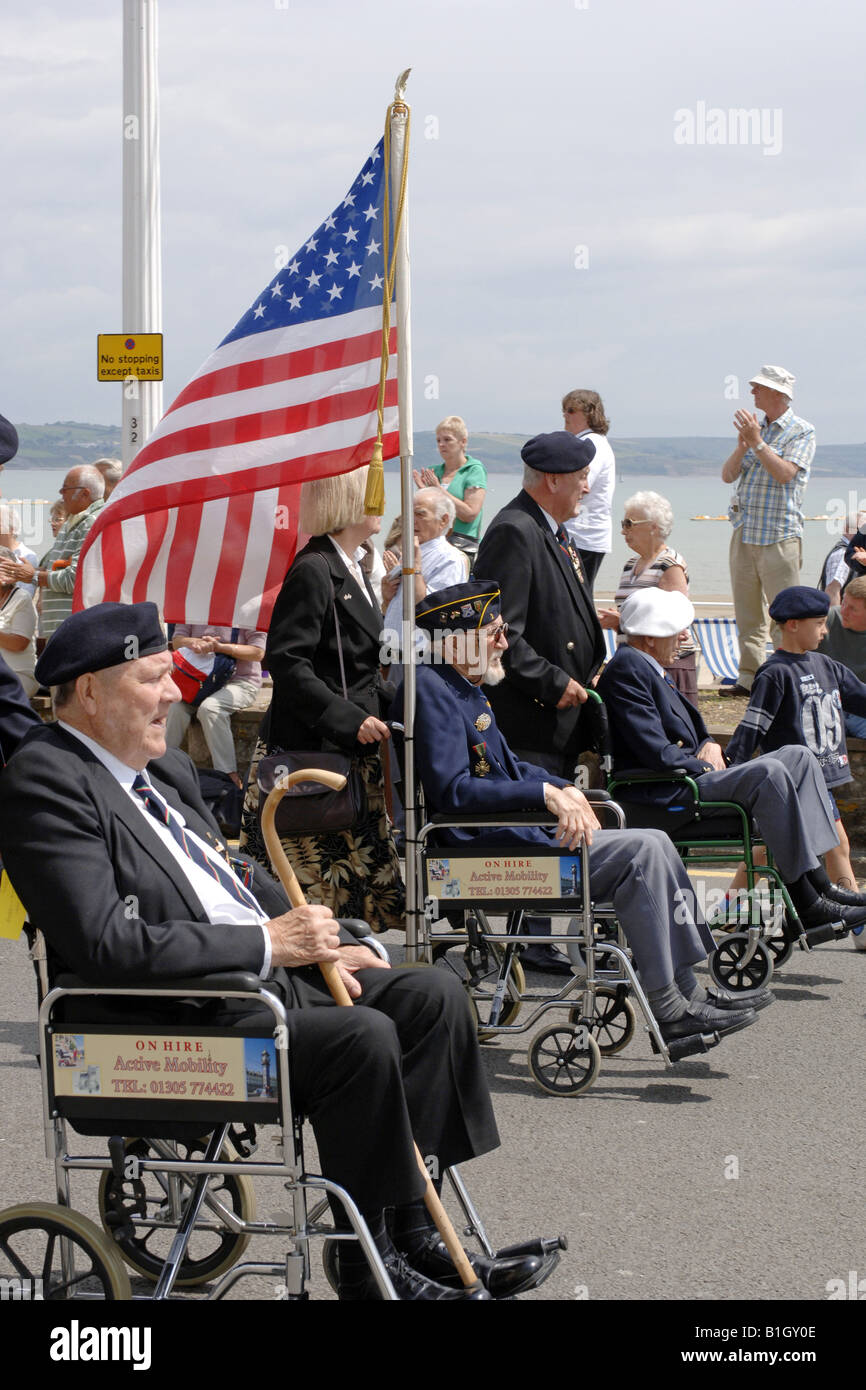 American VFW with the Stars and stripes is pushed in his wheelchair at ...