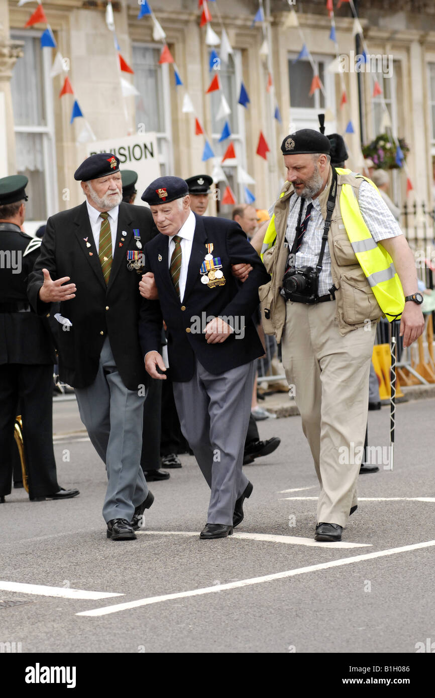 Old War Veteran feeling unwell being helped to a First Aid post Stock ...