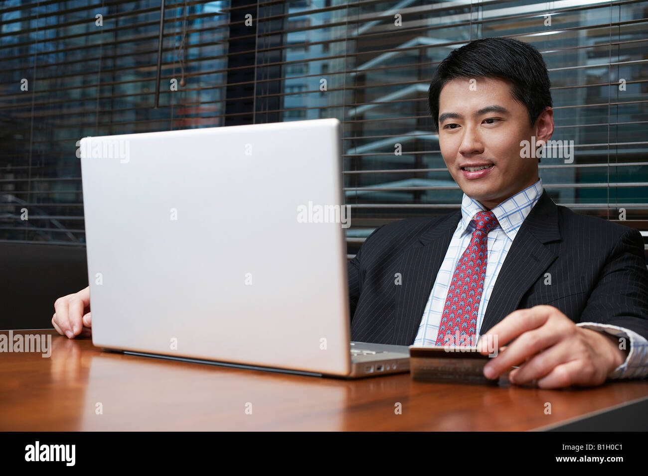 Business man using laptop in cafe Stock Photo - Alamy