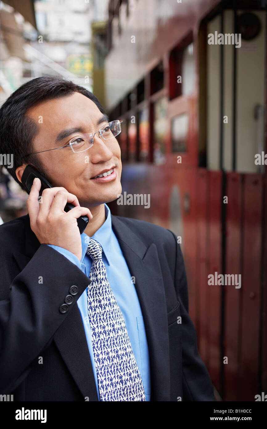 Business man using mobile phone on street Stock Photo - Alamy