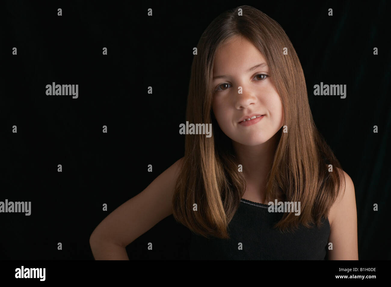 Girl (10-12) on black background, portrait Stock Photo - Alamy
