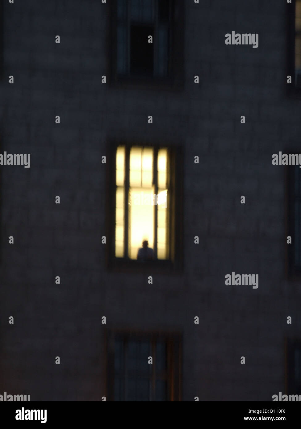 one person at office window at night Stock Photo - Alamy