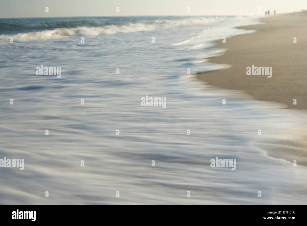 Wave washing on shore, blurred motion Stock Photo - Alamy