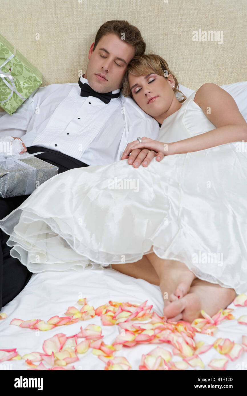 Bride and groom sleeping among presents Stock Photo - Alamy