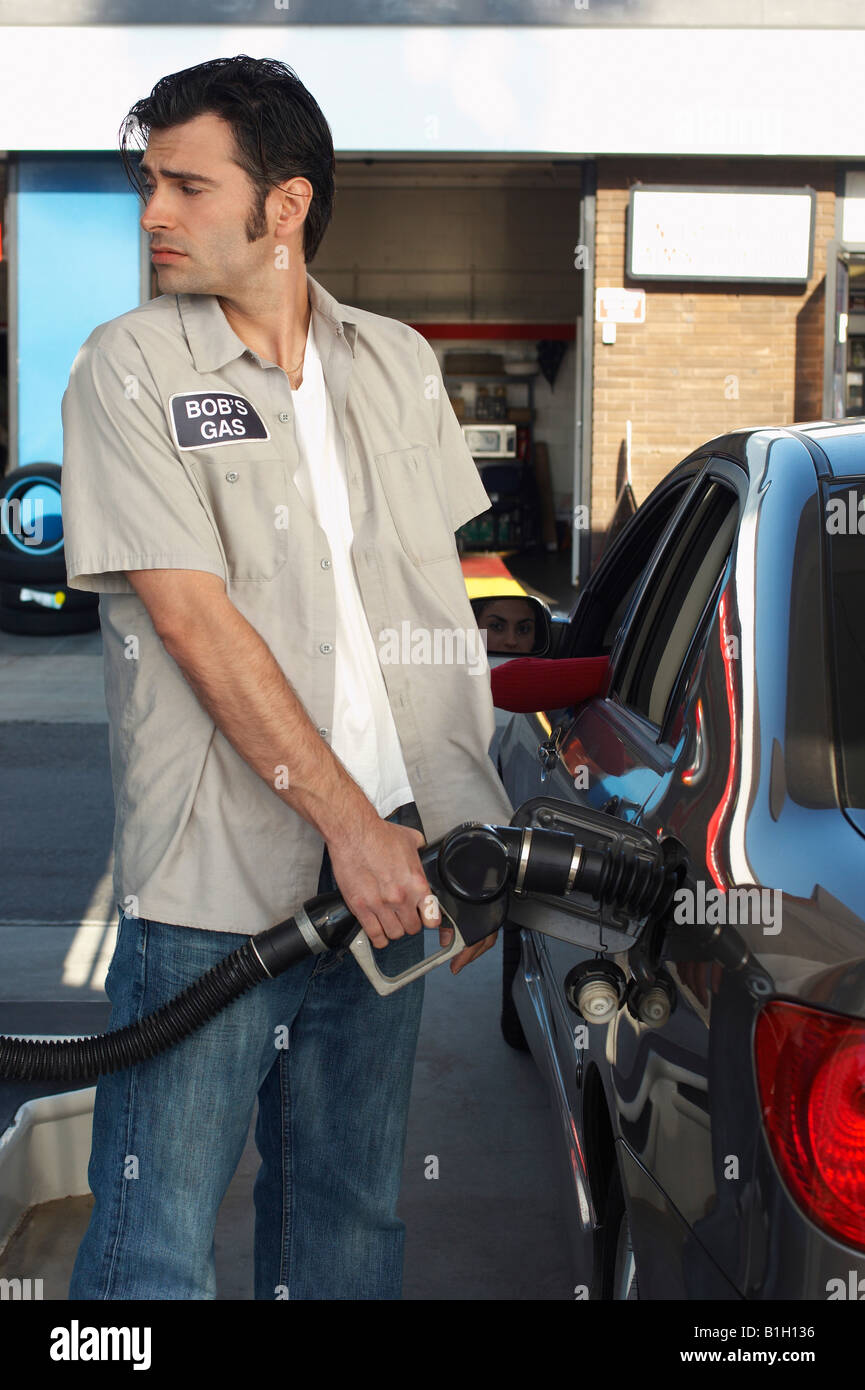 Service attendant pumping gas Stock Photo - Alamy