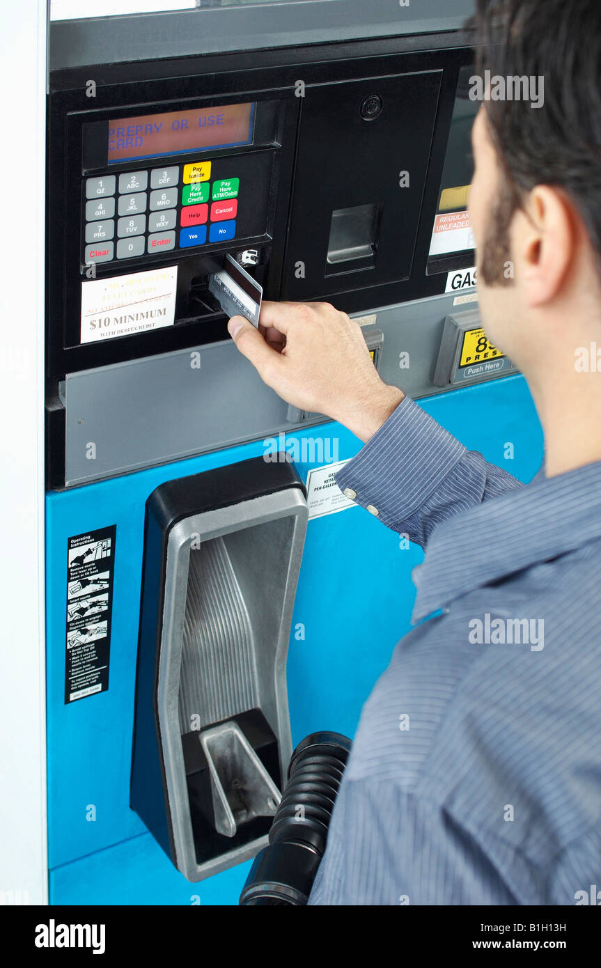 Man paying with credit card at fuel pump Stock Photo - Alamy