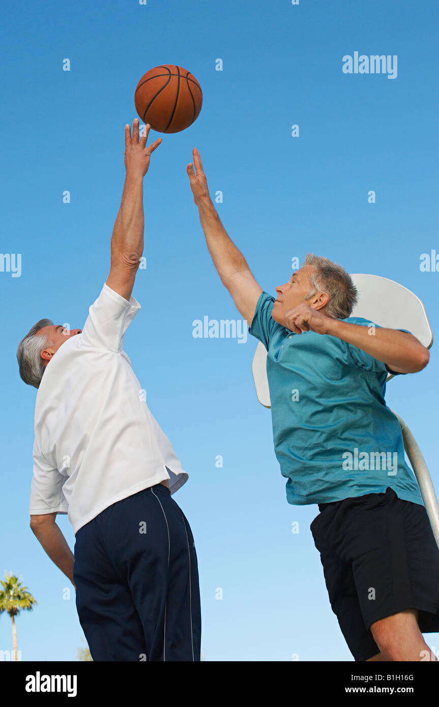 Senior men playing basketball on outdoor court Stock Photo - Alamy