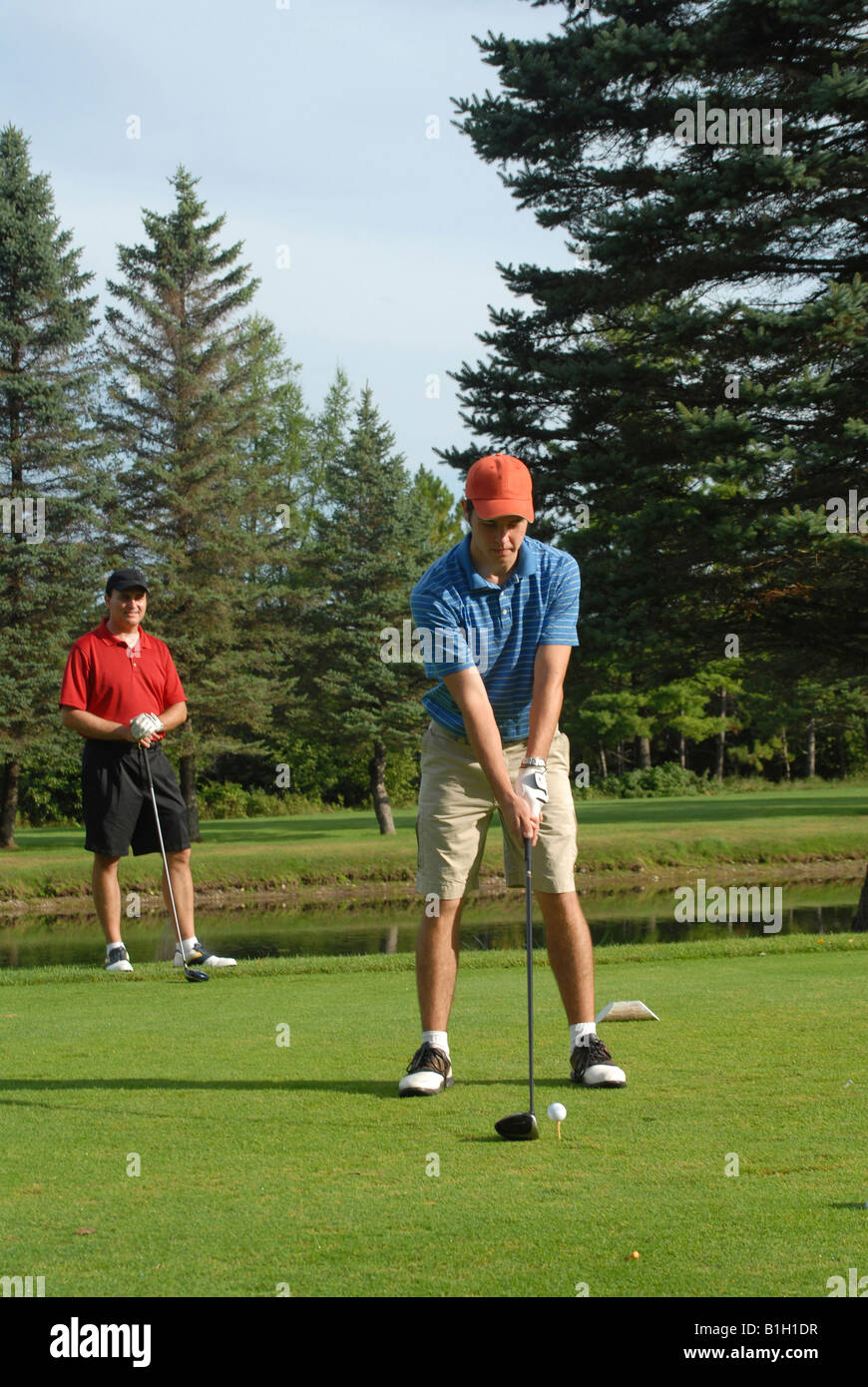 Two men playing golf Stock Photo - Alamy