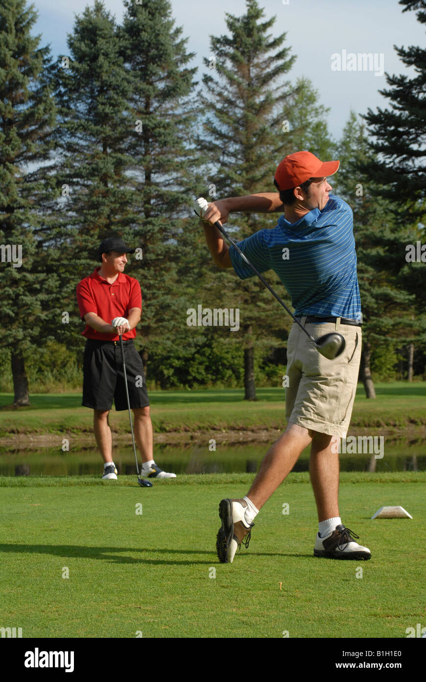 Two men playing golf Stock Photo - Alamy