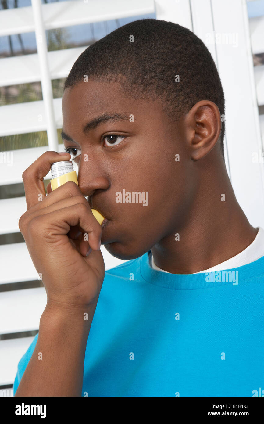 Young man using asthma inhaler Stock Photo - Alamy
