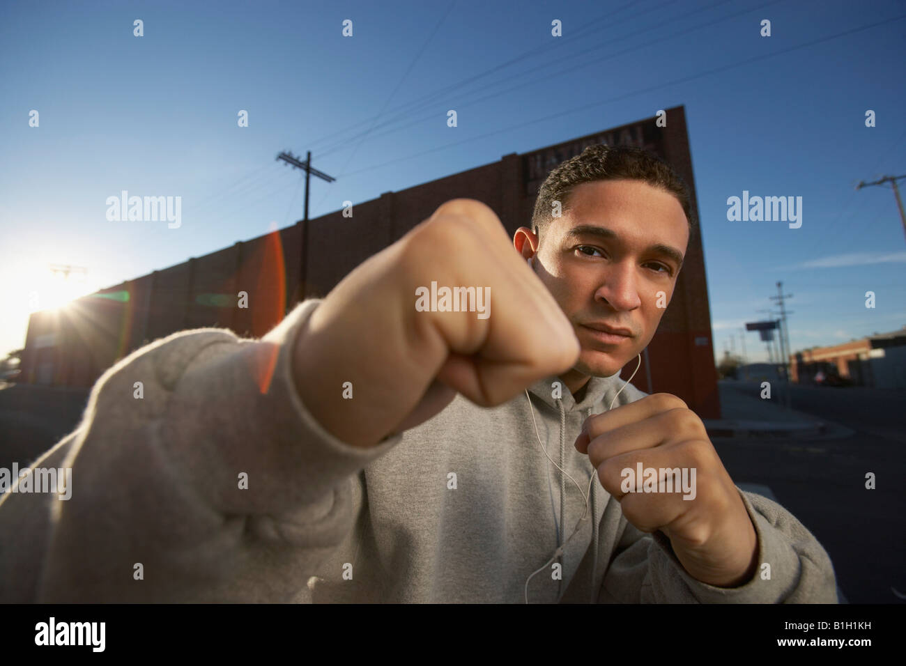 Portrait of man in fighting stance outdoors Stock Photo - Alamy