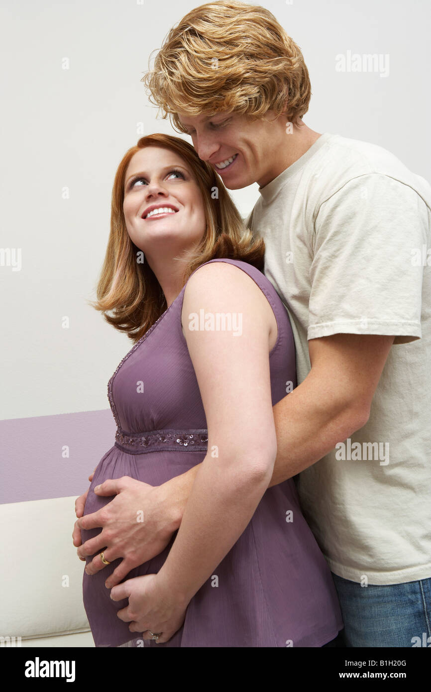 Expectant couple embracing at home, portrait Stock Photo - Alamy