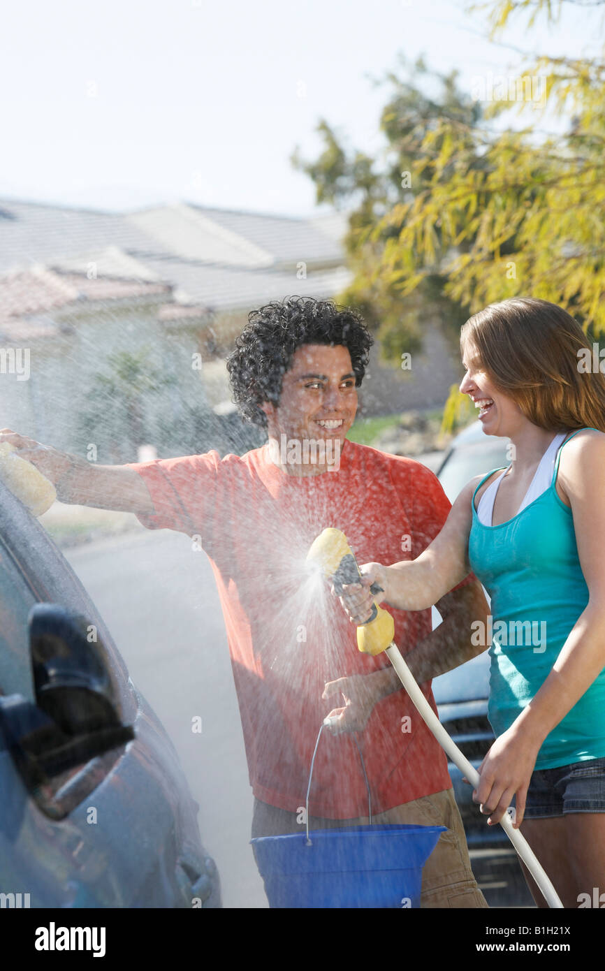 Young couple washing car Stock Photo - Alamy