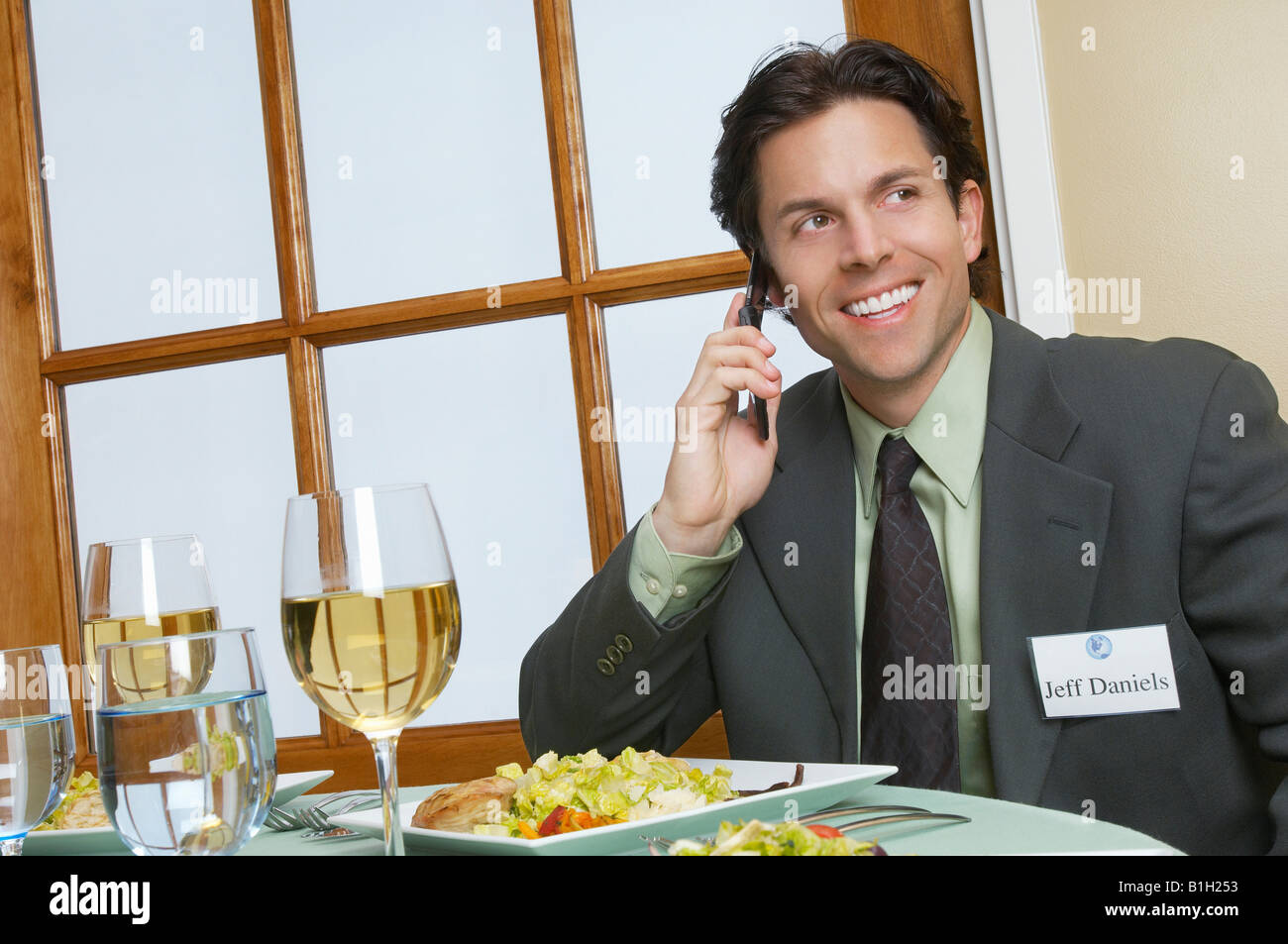 Mid adult business man talking on mobile at restaurant table Stock ...