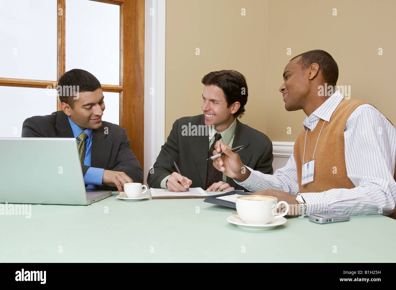 Three business men talking Stock Photo - Alamy