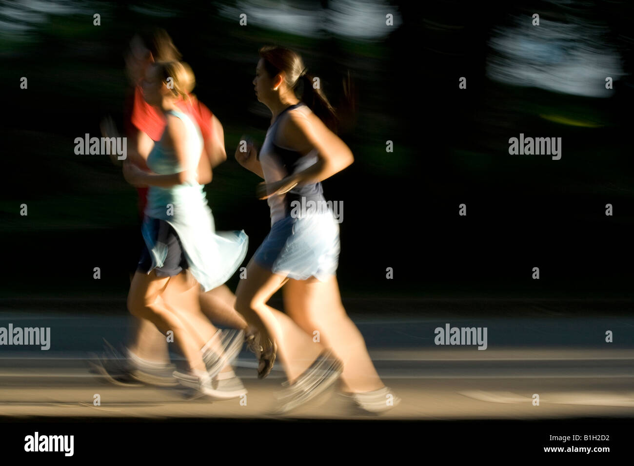 Joggers run through Central Park in New York Stock Photo - Alamy
