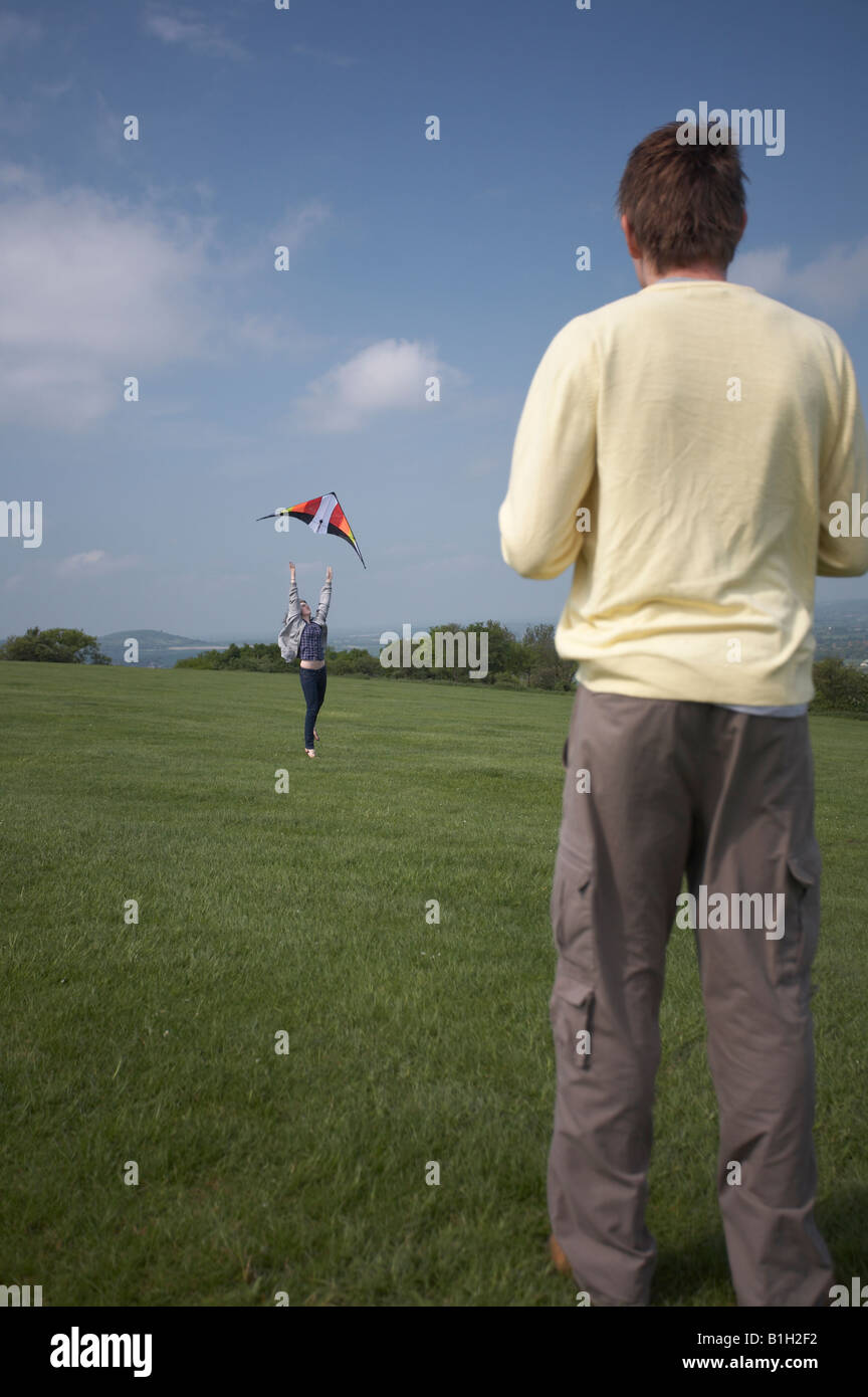 Young woman releasing kite Stock Photo - Alamy