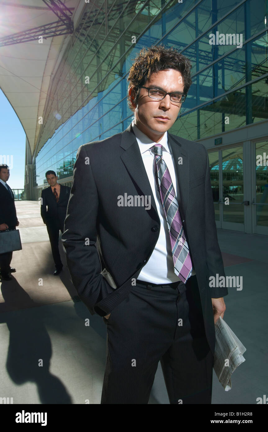 Portrait of businessman in front of office building Stock Photo - Alamy