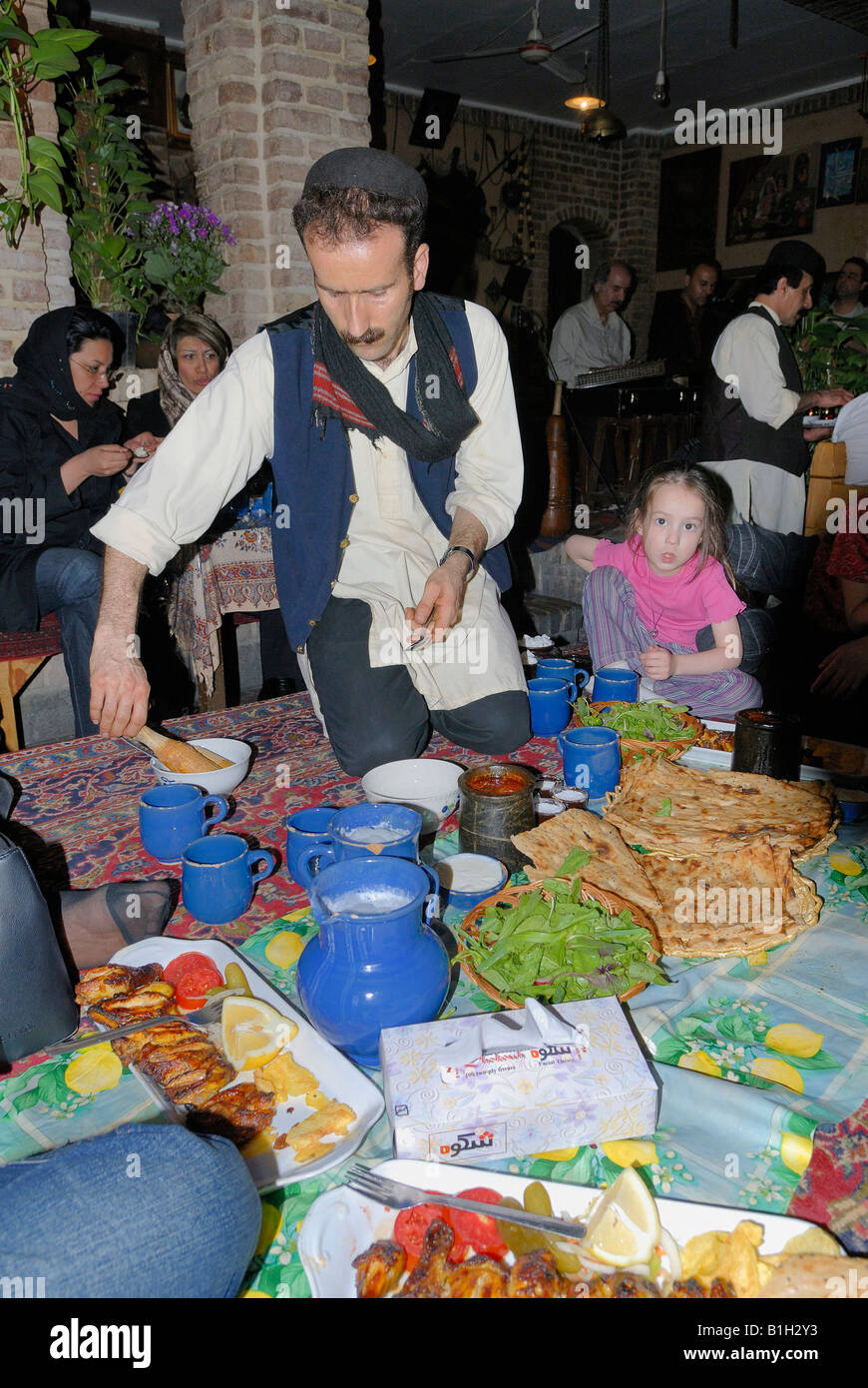 A waiter prepares local delicacy in one of Tehran's popular restaurants ...
