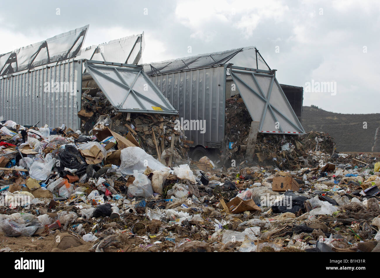 Trucks dumping waste at landfill site Stock Photo - Alamy