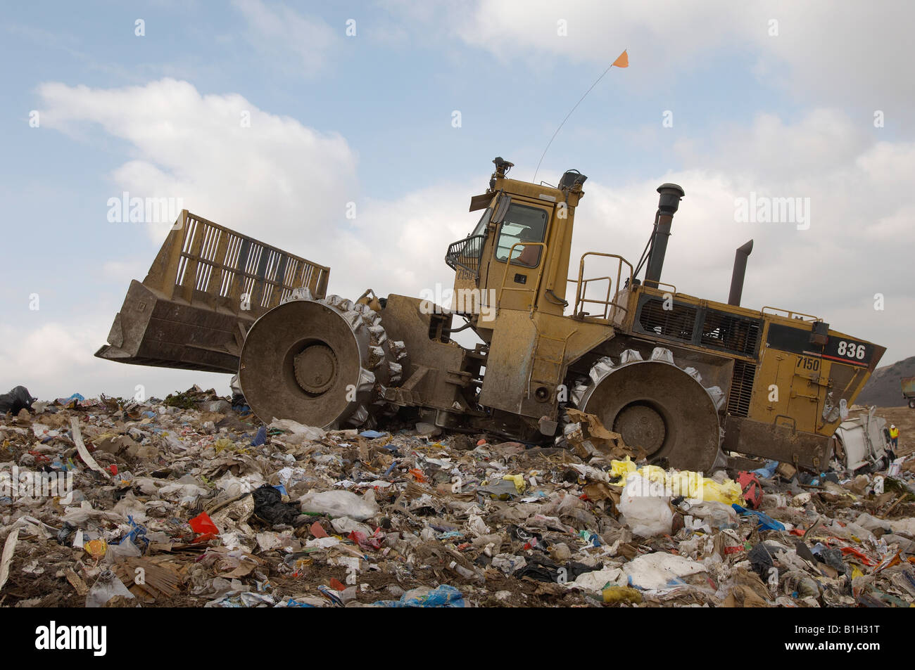 Digger working at landfill site Stock Photo - Alamy