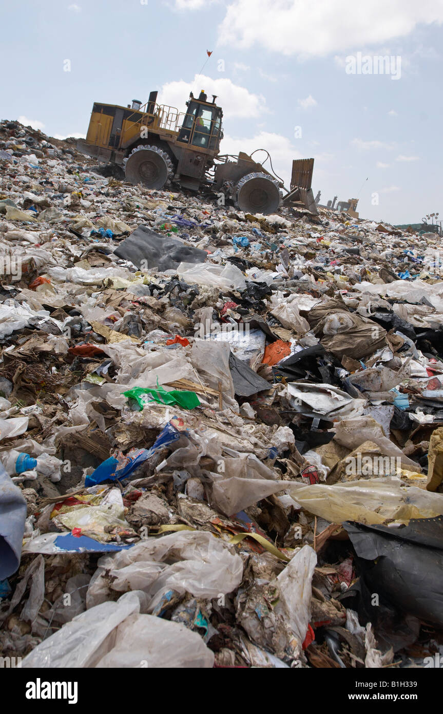 Digger working at landfill site Stock Photo - Alamy