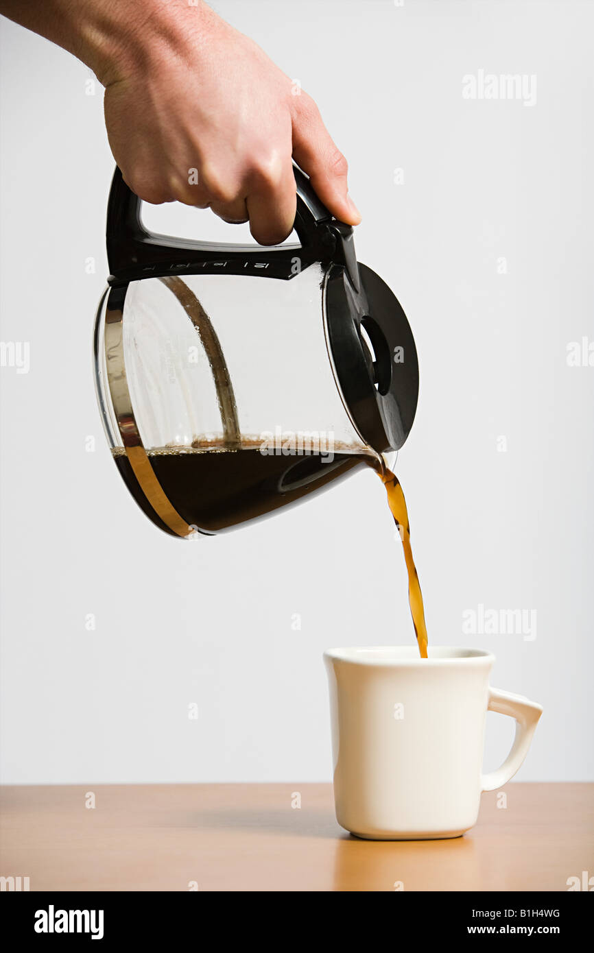 Person pouring coffee Stock Photo - Alamy