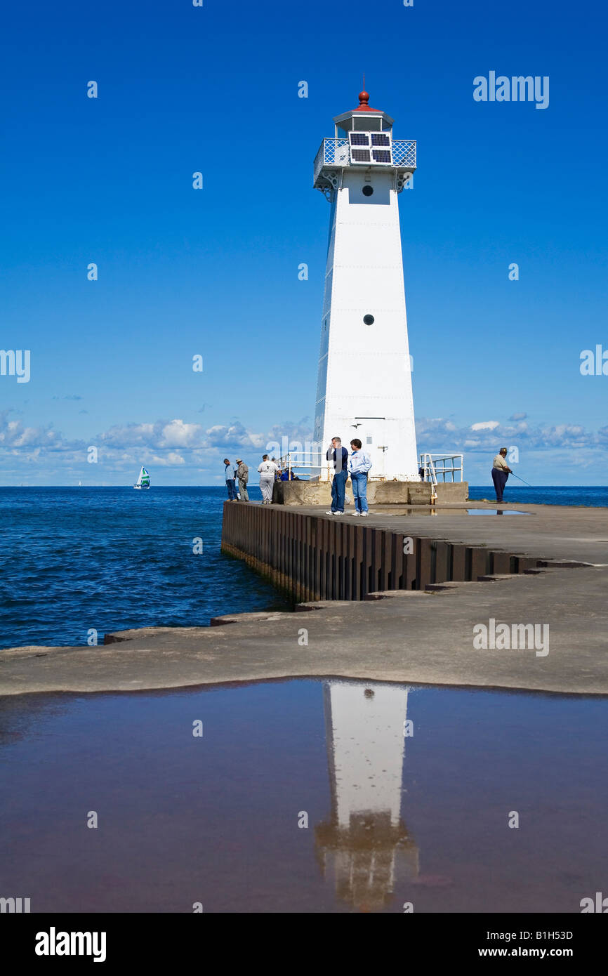 Reflection of a lighthouse in water, Sodus Outer Lighthouse, Greater ...