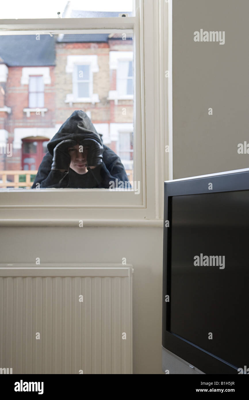 Burglar looking through window Stock Photo - Alamy