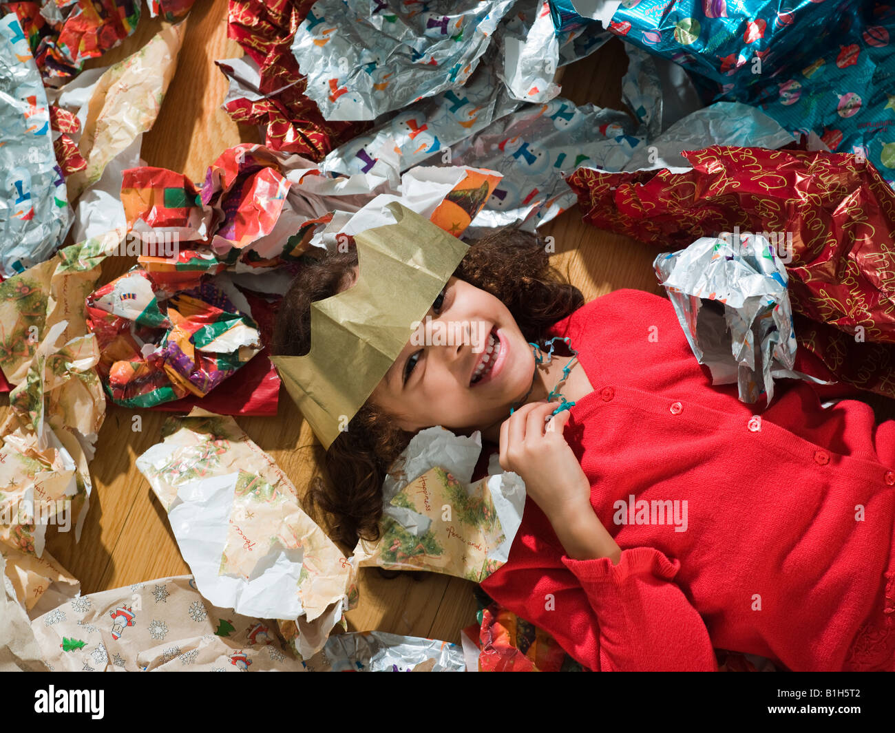 Girl surrounded by wrapping paper Stock Photo - Alamy