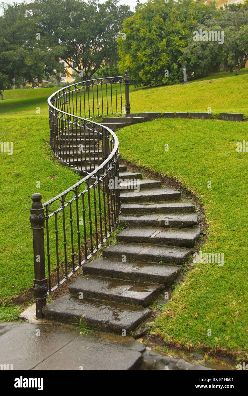 Winding steps and a wrought iron handrail on a hillside, Costa Rica ...