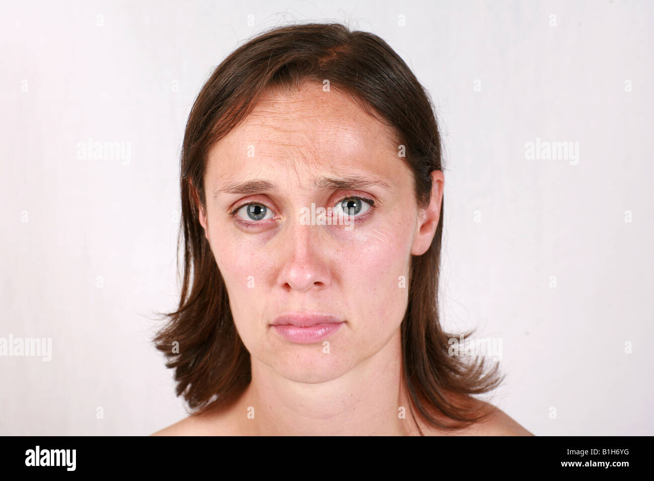 Young brunette woman head shot closeup with sad upset despondent ...