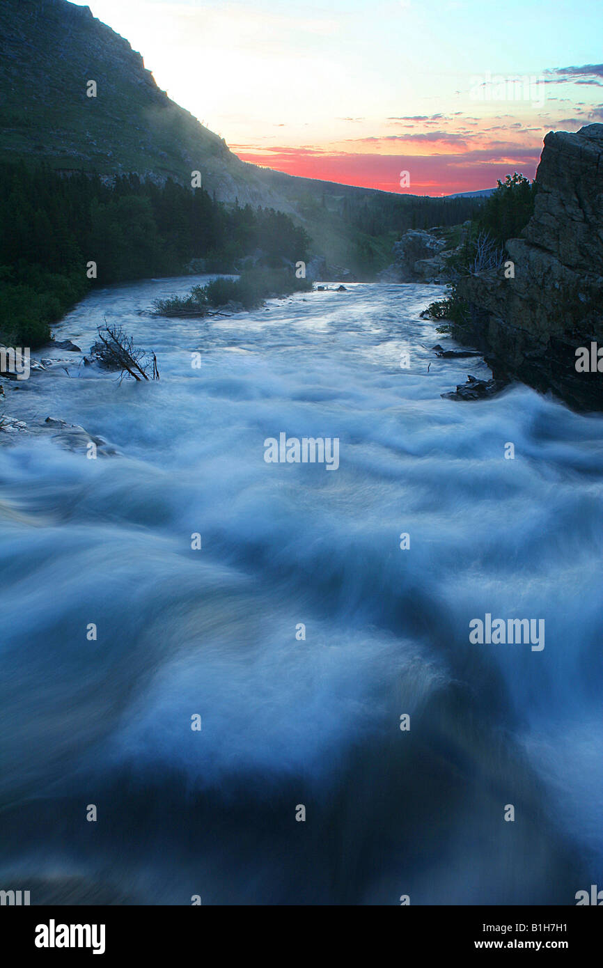 River flowing around rocks at sunrise, Sunrift Gorge, US Glacier ...