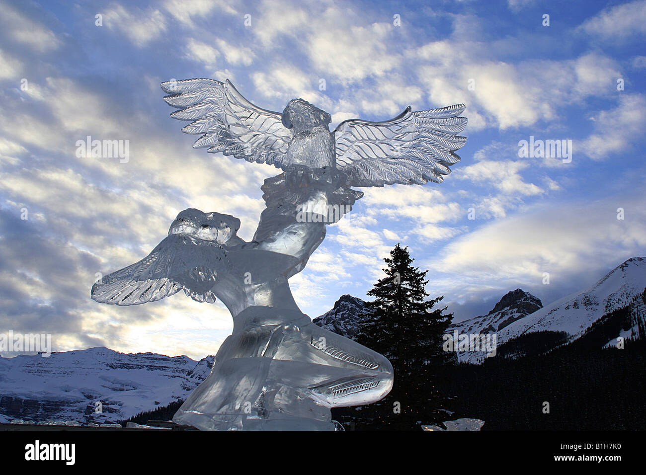 Low angle view of an ice sculpture with mountains in the background ...