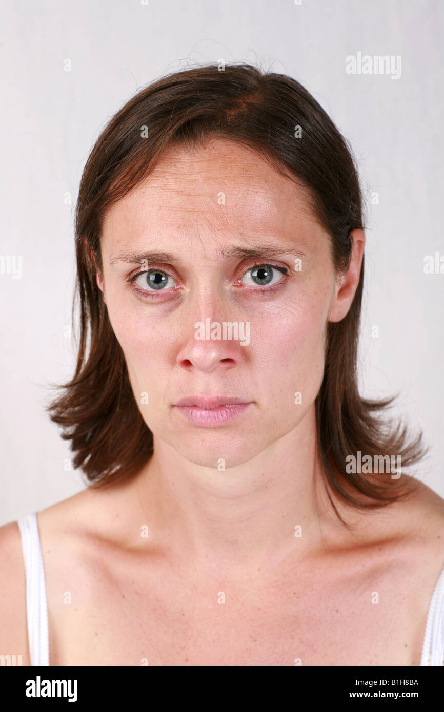 Young brunette woman head shot closeup sad upset despondent depressed ...