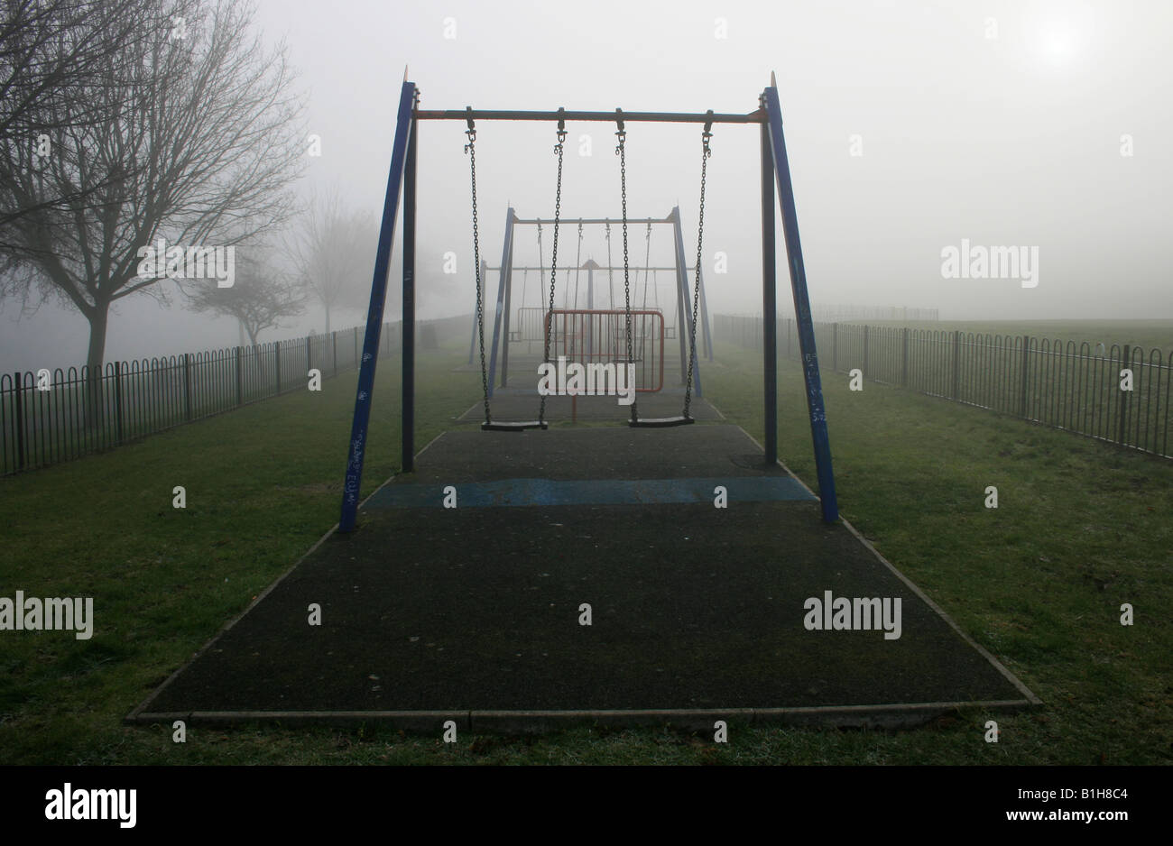Foggy morning on a playground in a park Stock Photo - Alamy