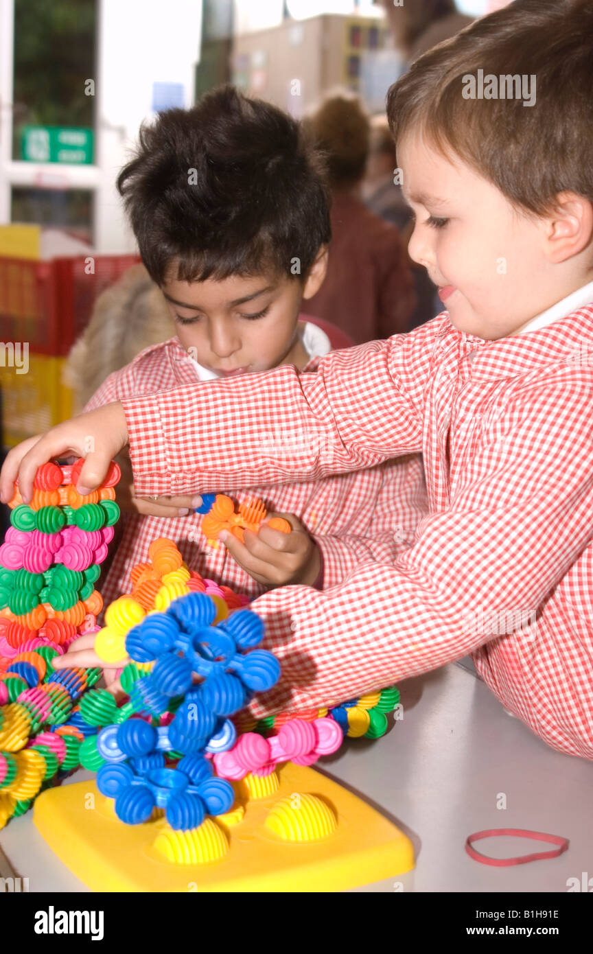 young schoolboy playing with a building toy Stock Photo - Alamy