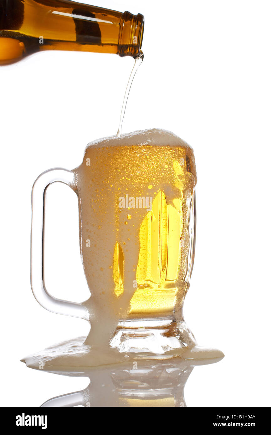 Pouring beer into mug reflected over white background Stock Photo - Alamy