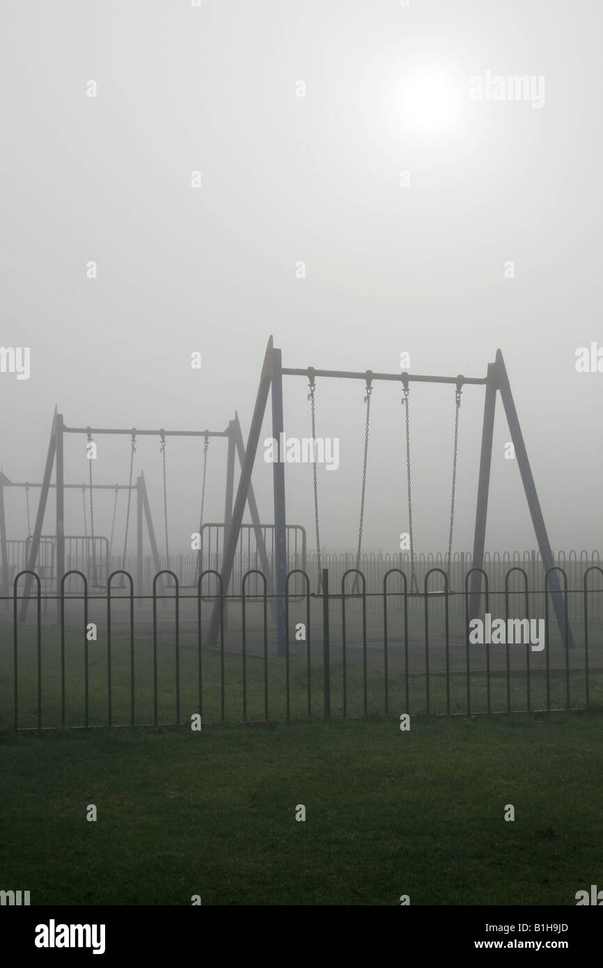 Foggy morning on a playground in a park Stock Photo - Alamy
