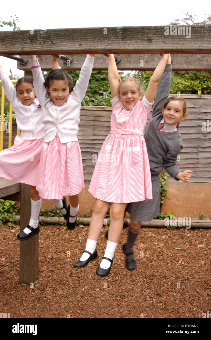 girls on monkey bars in school uniforms Stock Photo - Alamy