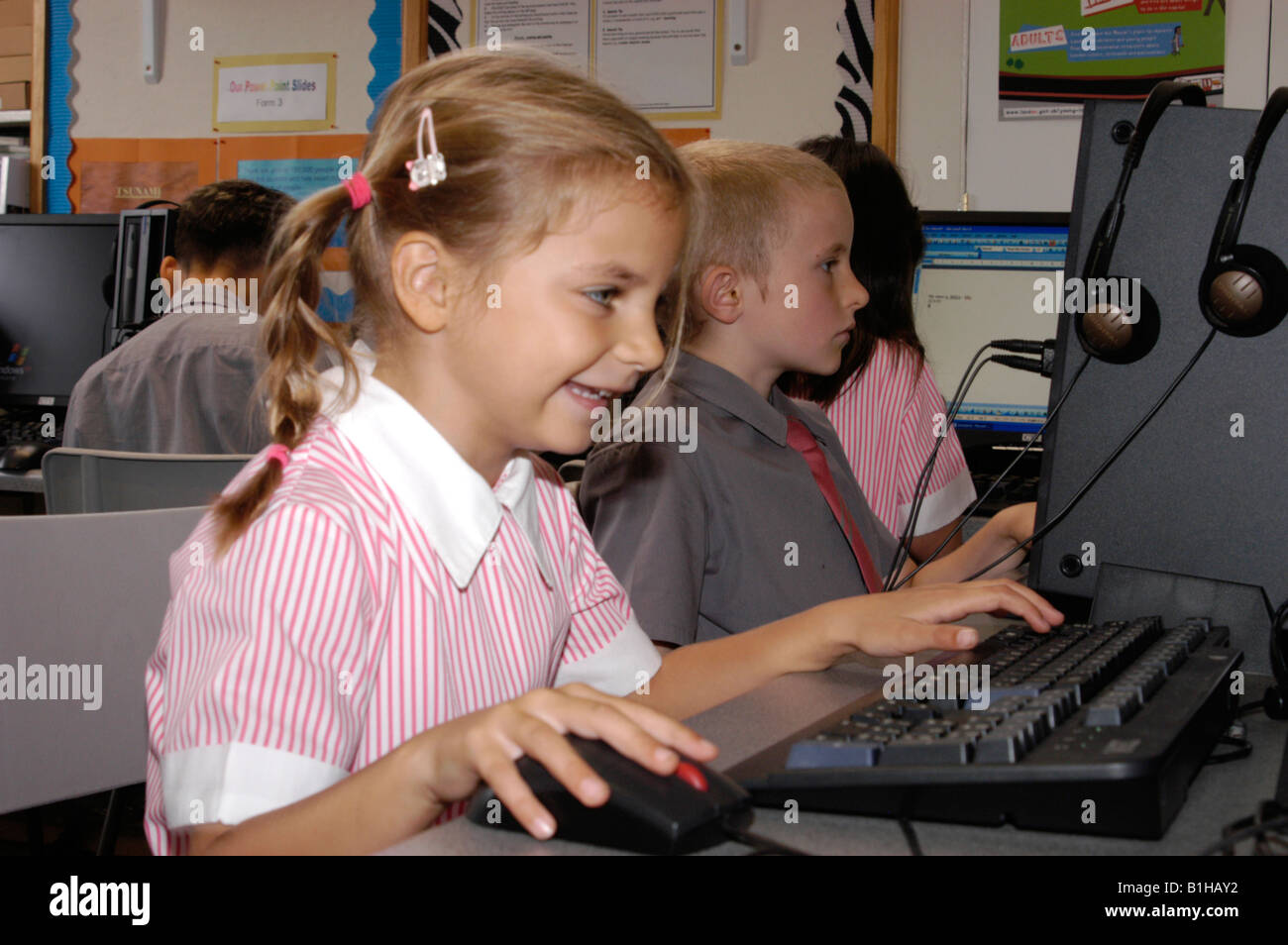 children in school learning on computers Stock Photo - Alamy