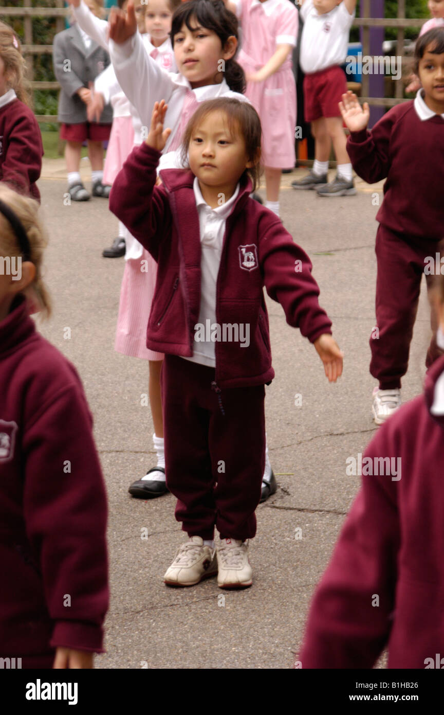 children in school playground moving their arms Stock Photo - Alamy