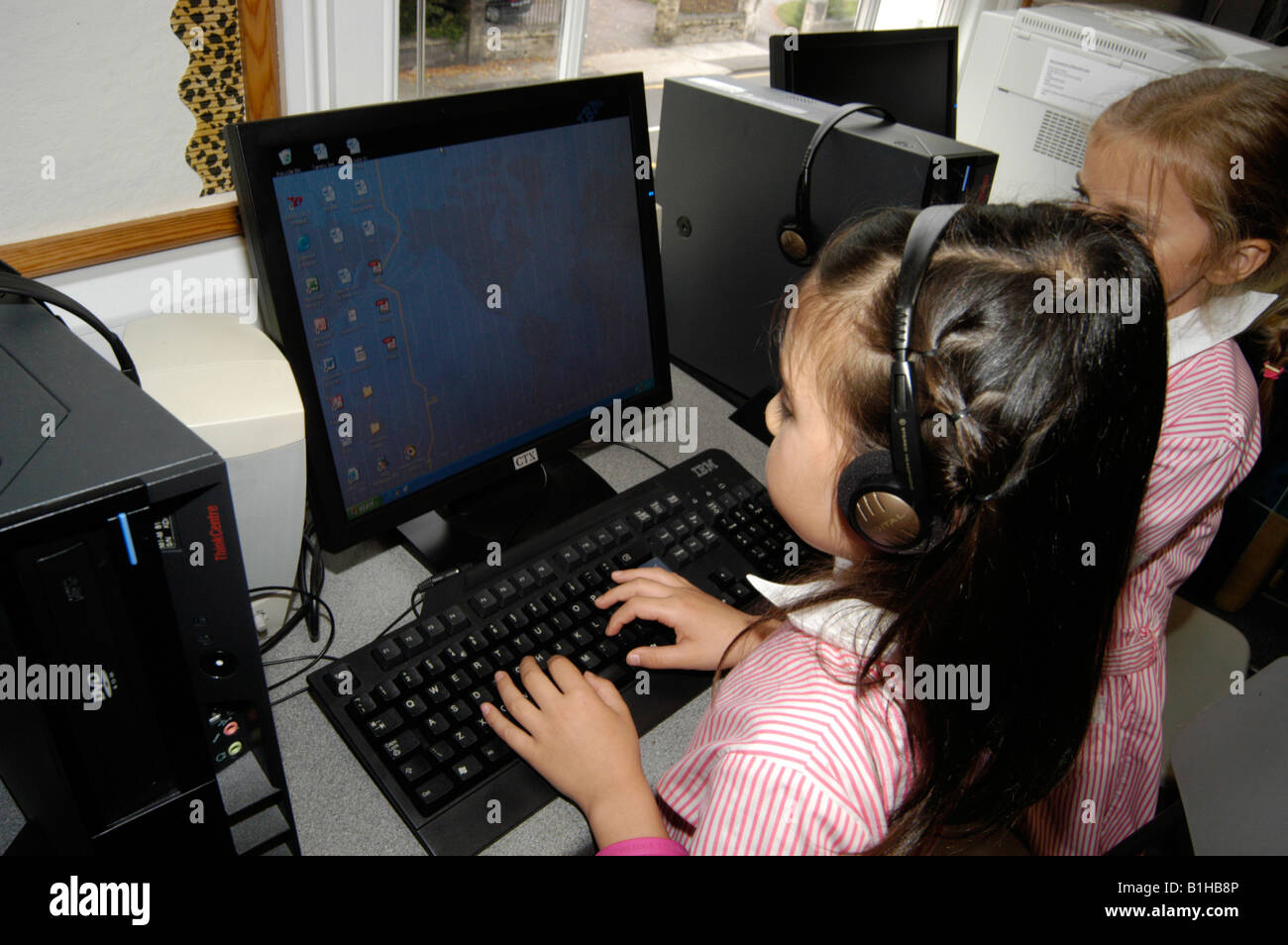 children in school learning on computers Stock Photo - Alamy
