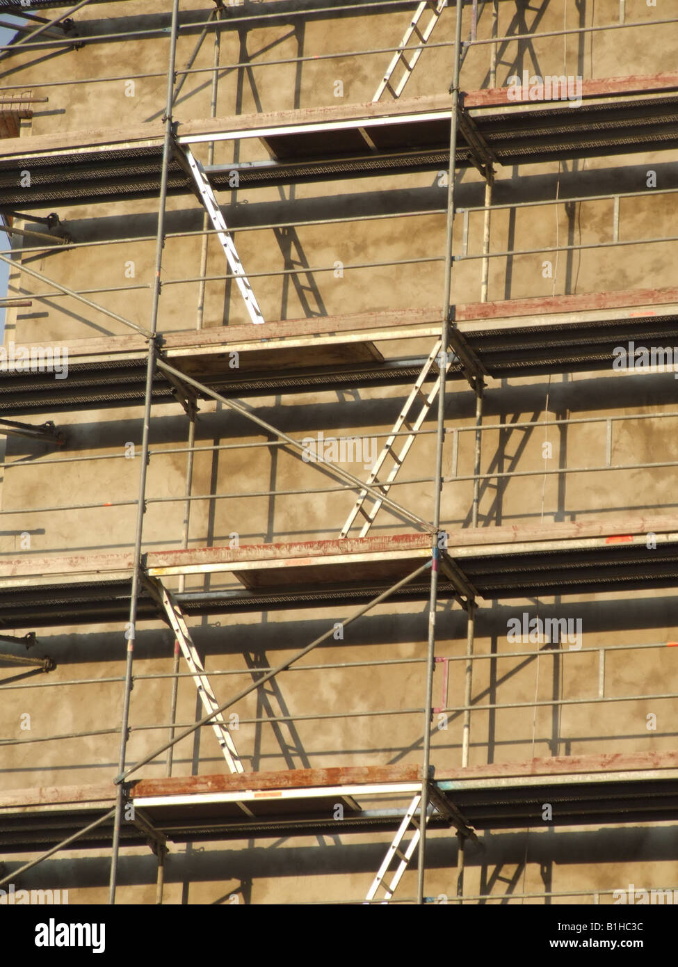 ladders and scaffolding on property building Stock Photo - Alamy